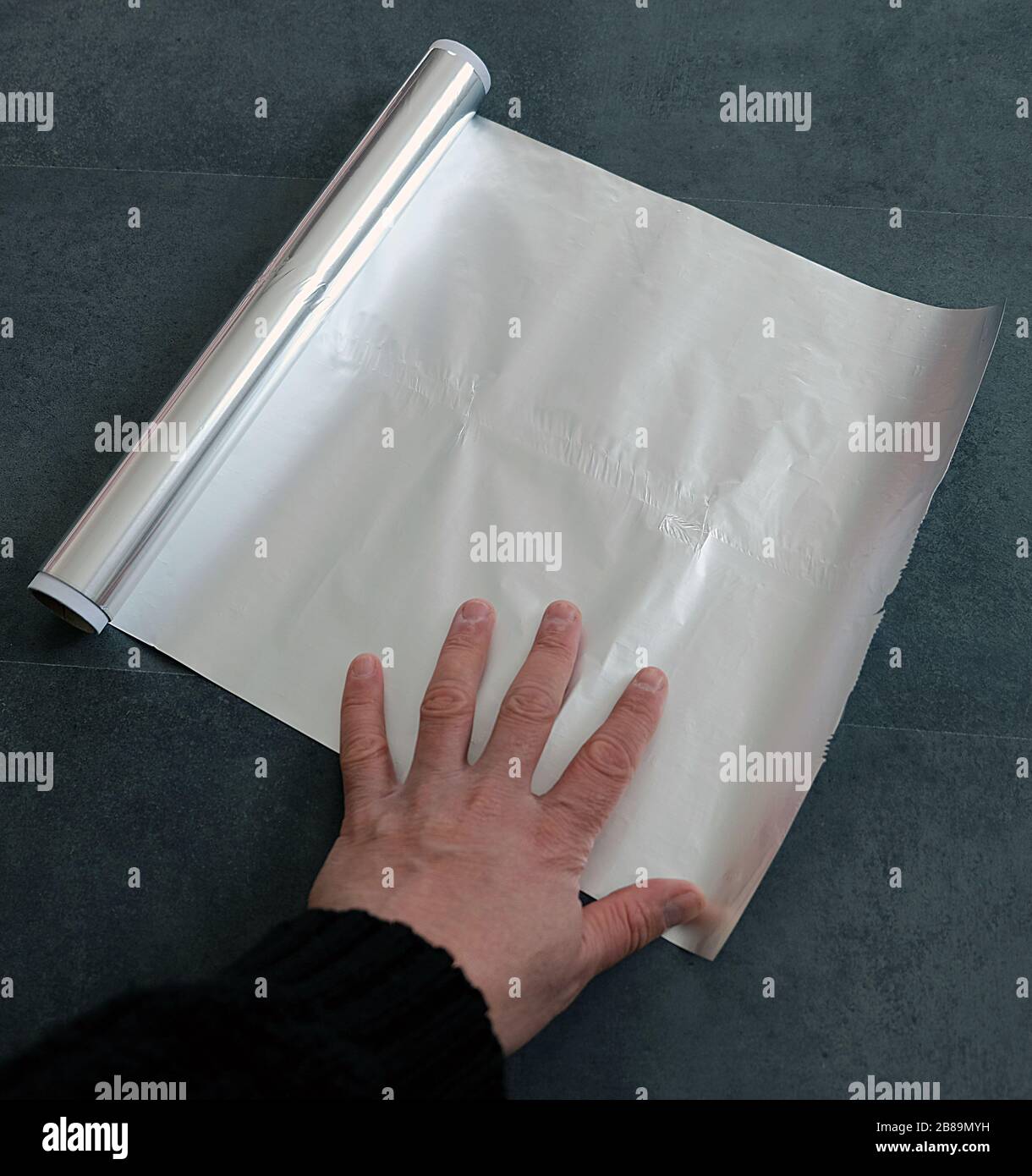 aluminum foil, rolled aluminum foil, close-up on a black background ...