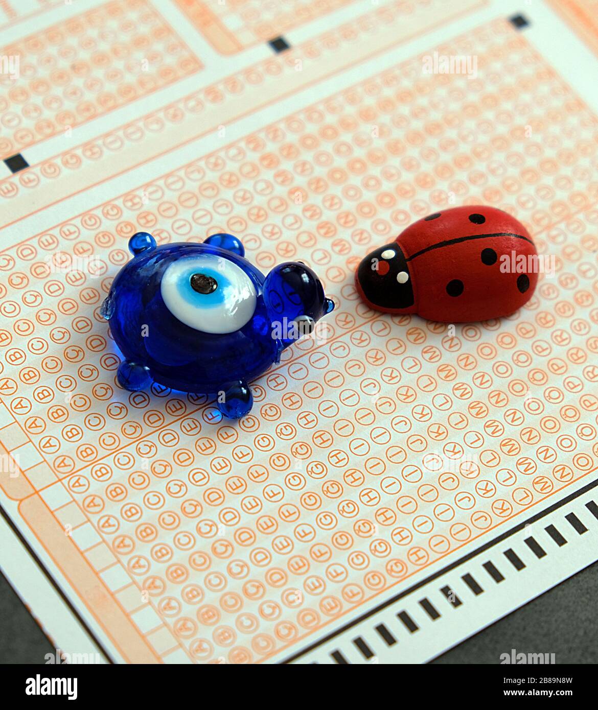 ladybug,evil eye bead and optical exam paper, exam and luck Stock Photo ...