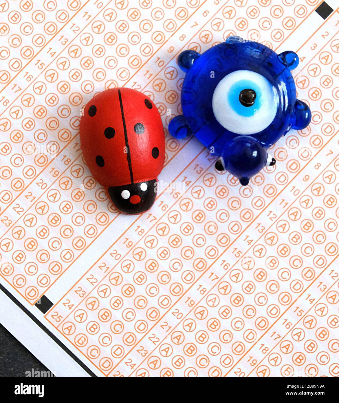 ladybug,evil eye bead and optical exam paper, exam and luck Stock Photo ...