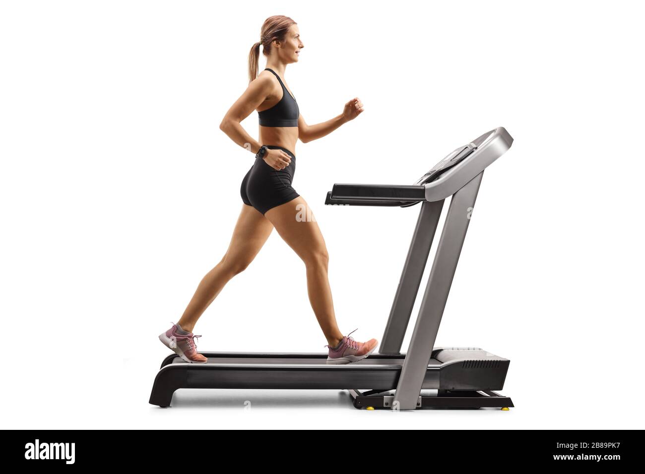 Full length profile shot of a muscular young woman running on a ...