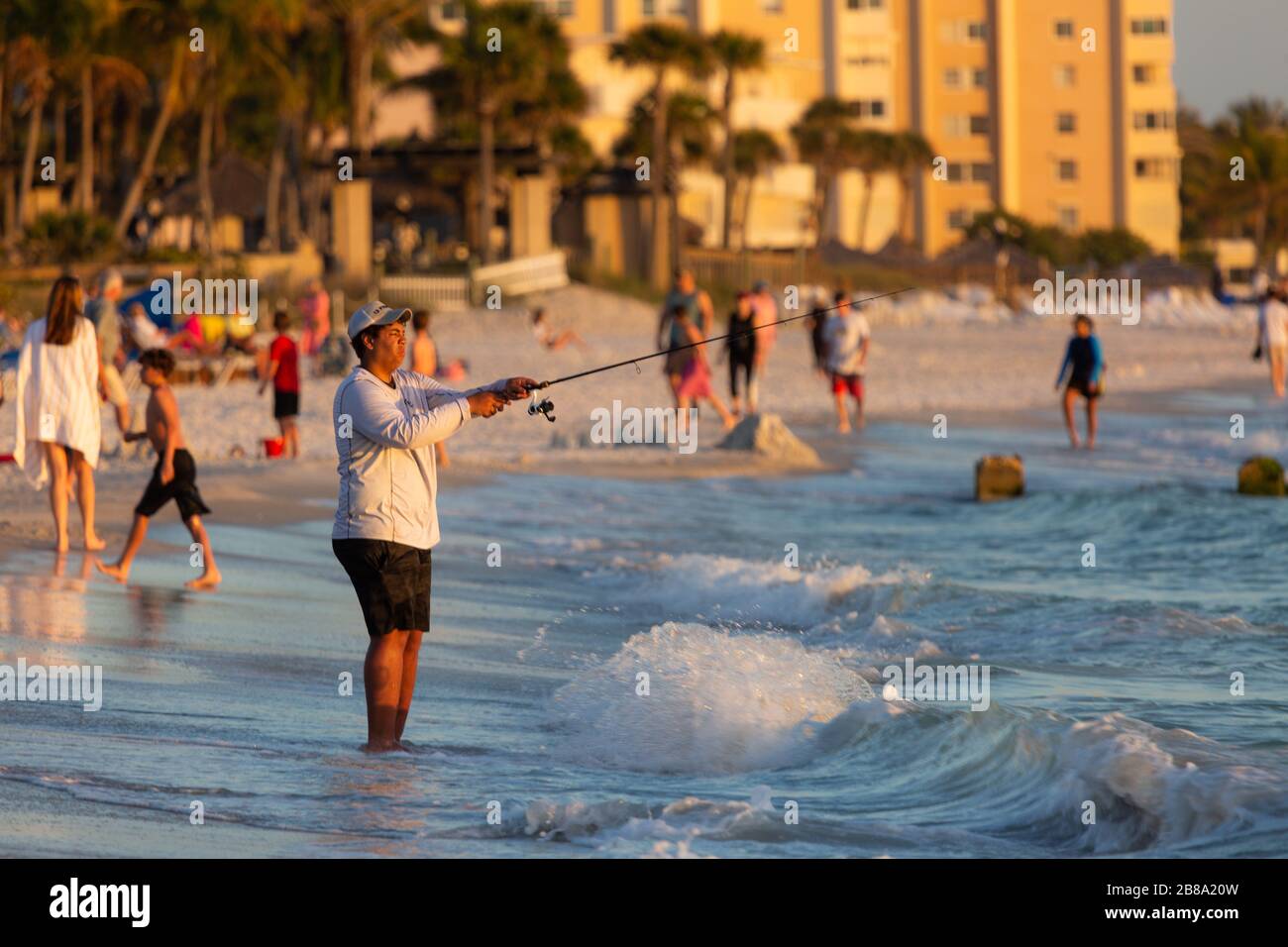 Lido Beach, Florida, USA - March 20, 2020. A man fishes in the Gulf of ...