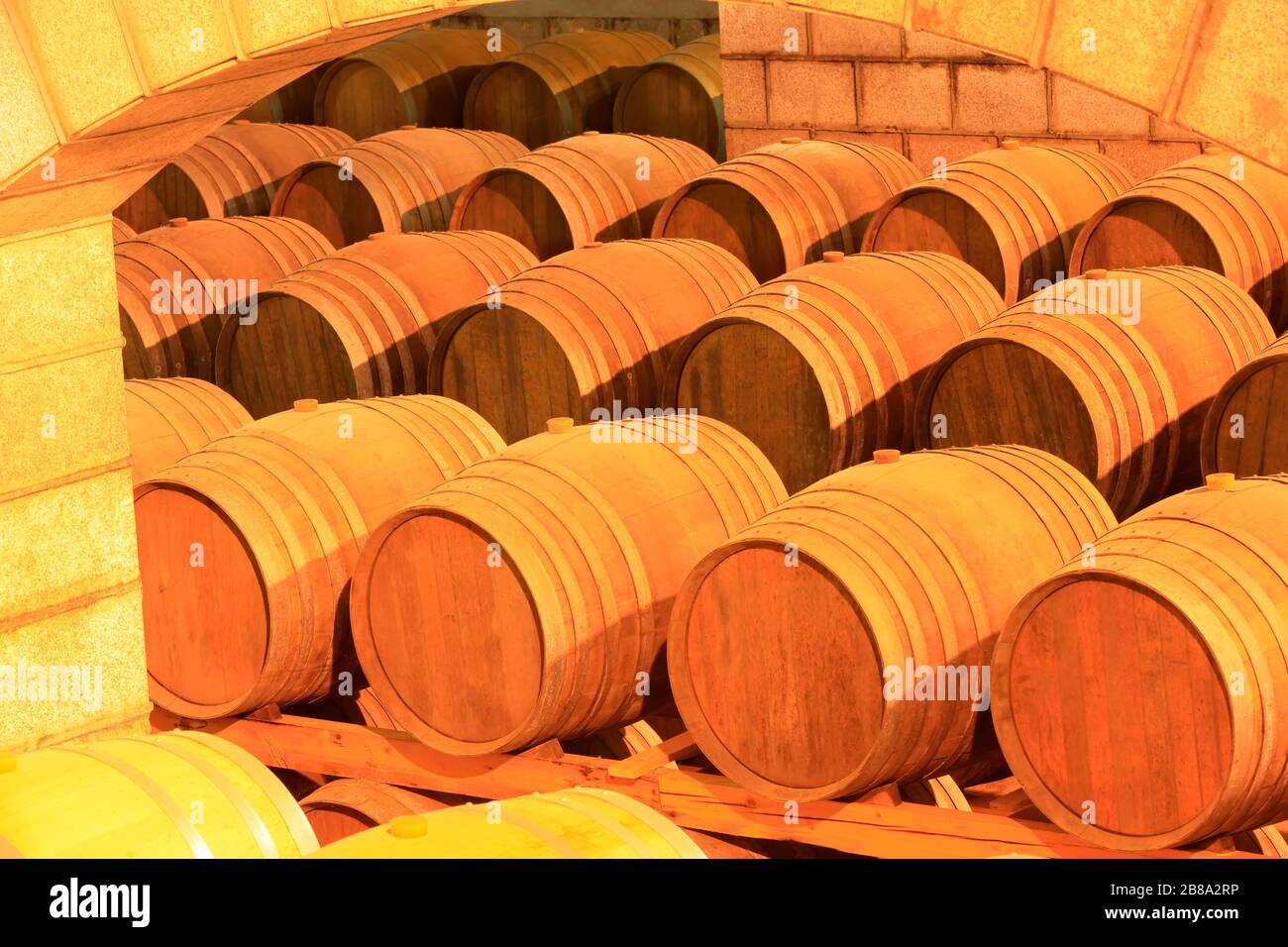 Wine barrels stacked in the cellar of the winery Stock Photo - Alamy