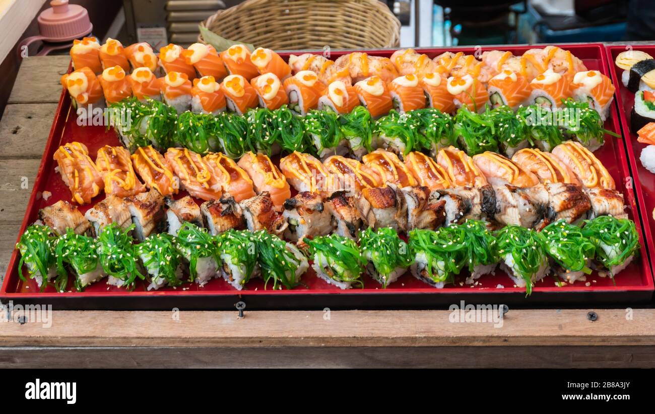 Many types of sushi, arranged in a row, ready to eat Stock Photo - Alamy