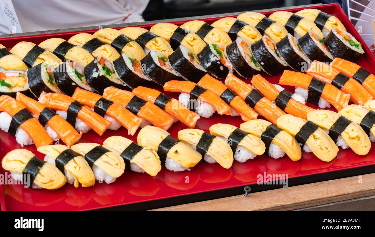 Many types of sushi, arranged in a row, ready to eat Stock Photo - Alamy