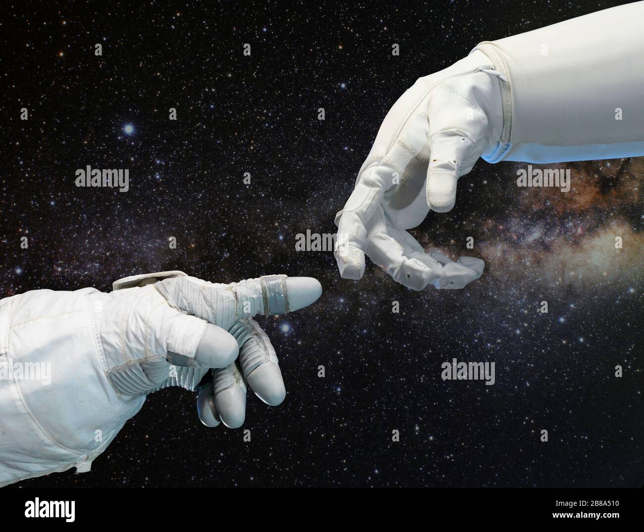 Astronaut and robotic hand in contact. Elements of this image furnished ...