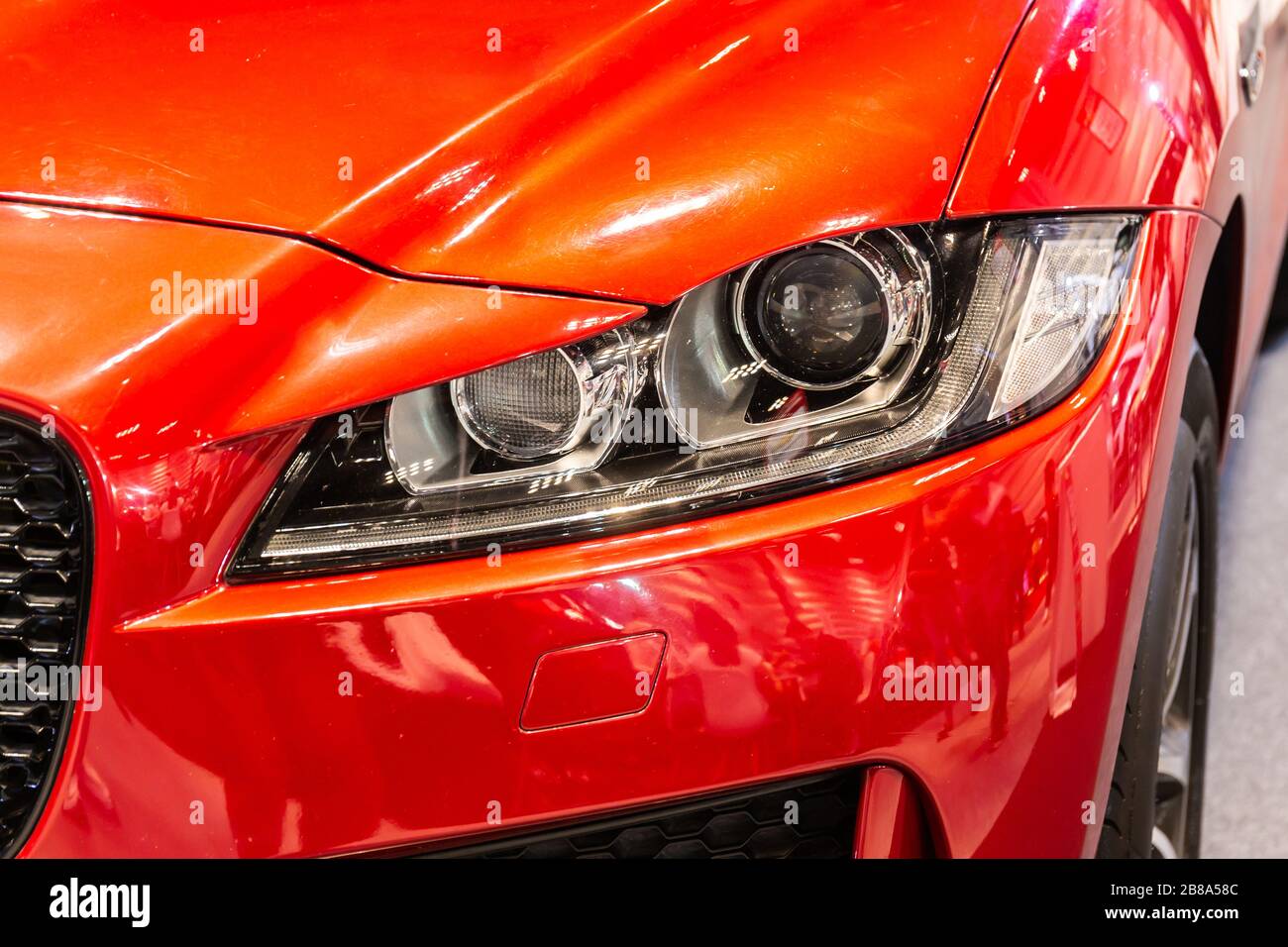 Close up of detail on one of the LED headlights modern and luxury red ...