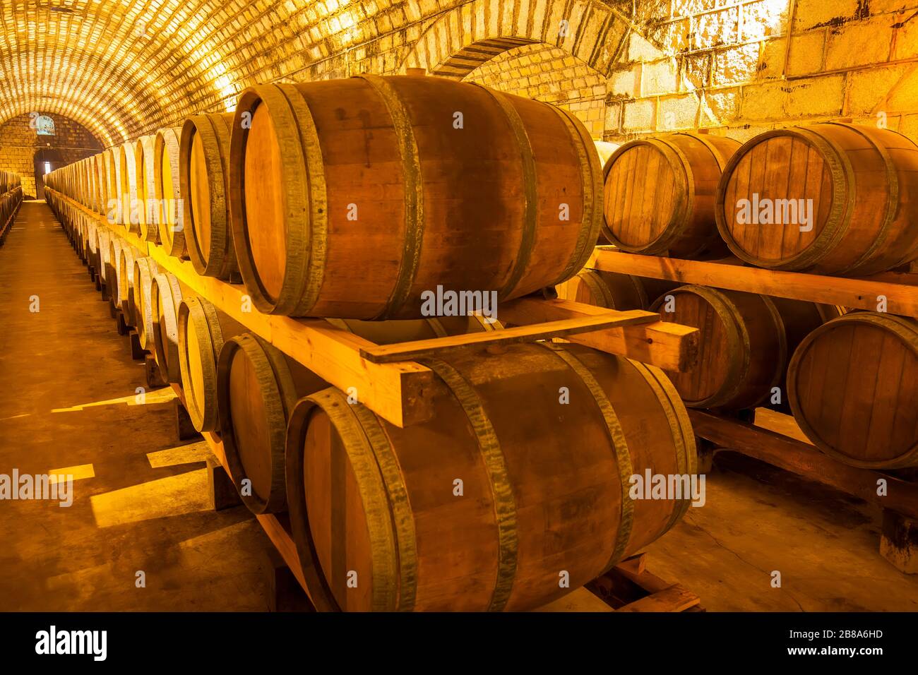 Wine barrels stacked in the cellar of the winery Stock Photo - Alamy