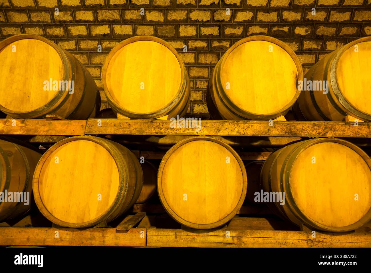 Wine barrels stacked in the cellar of the winery Stock Photo - Alamy