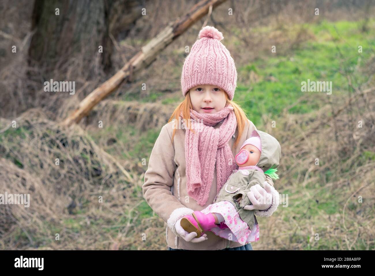 Hands holding toy doll hi-res stock photography and images - Alamy