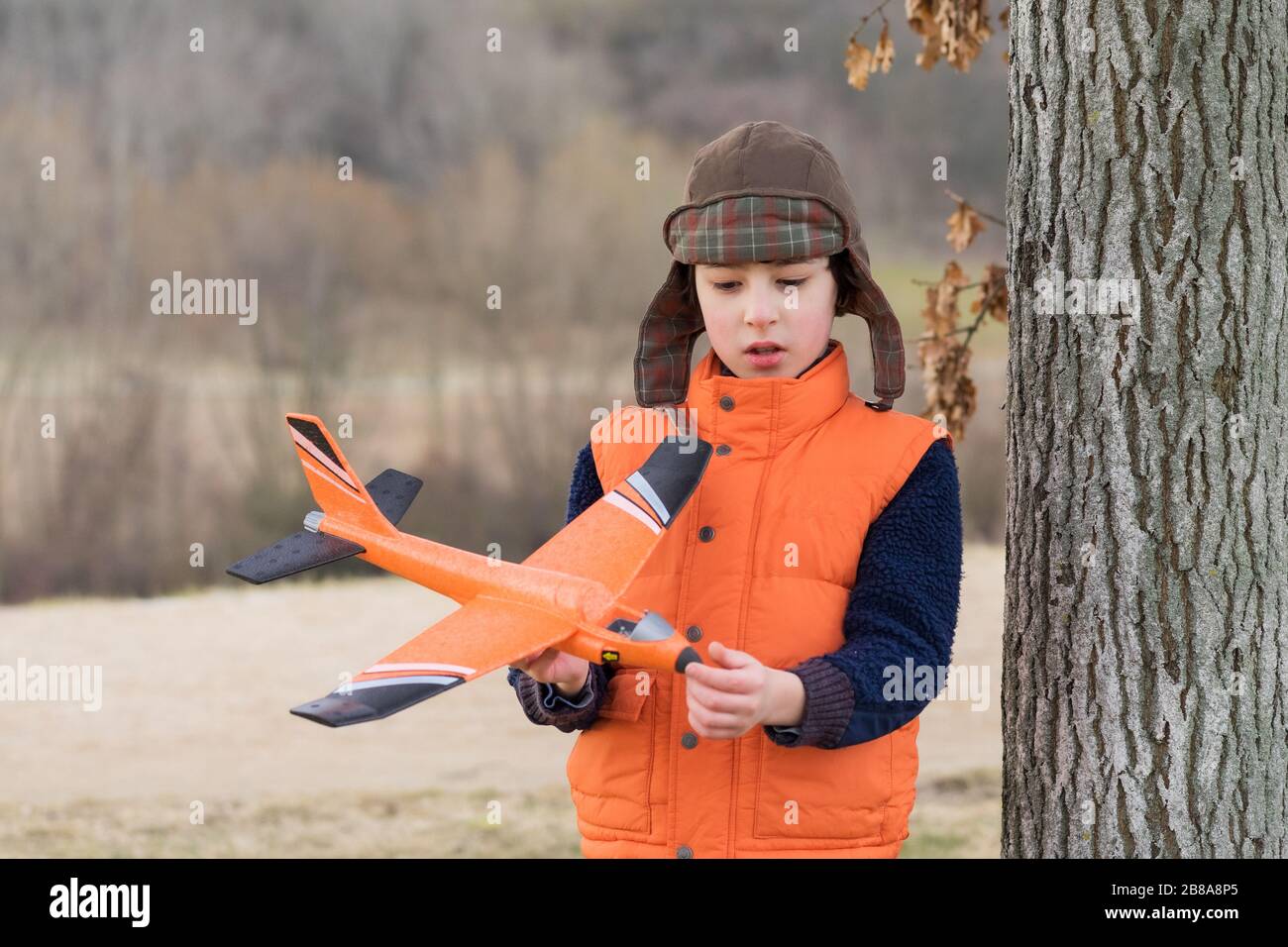Boy playing in nature with a model of a glider (airplane Stock Photo ...
