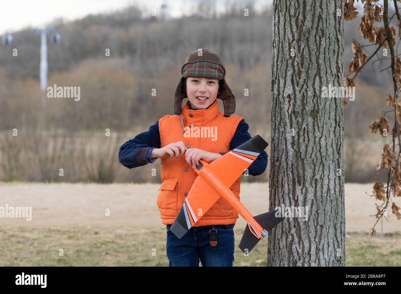 Boy playing in nature with a model of a glider (airplane Stock Photo ...