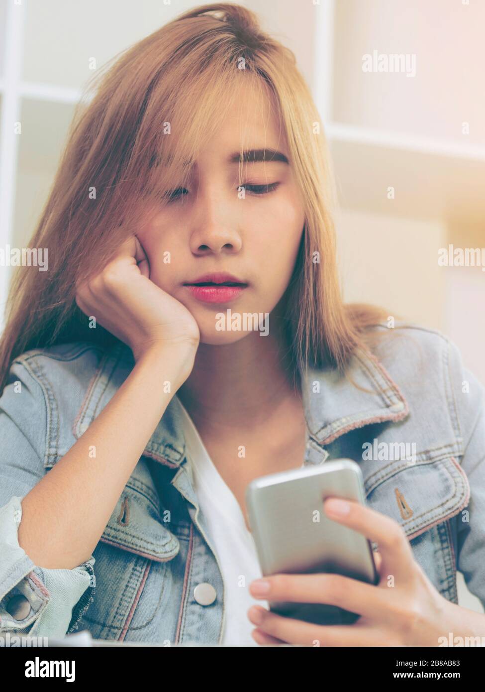 Unhappy businesswoman looks at smart phone while feeling upset about ...