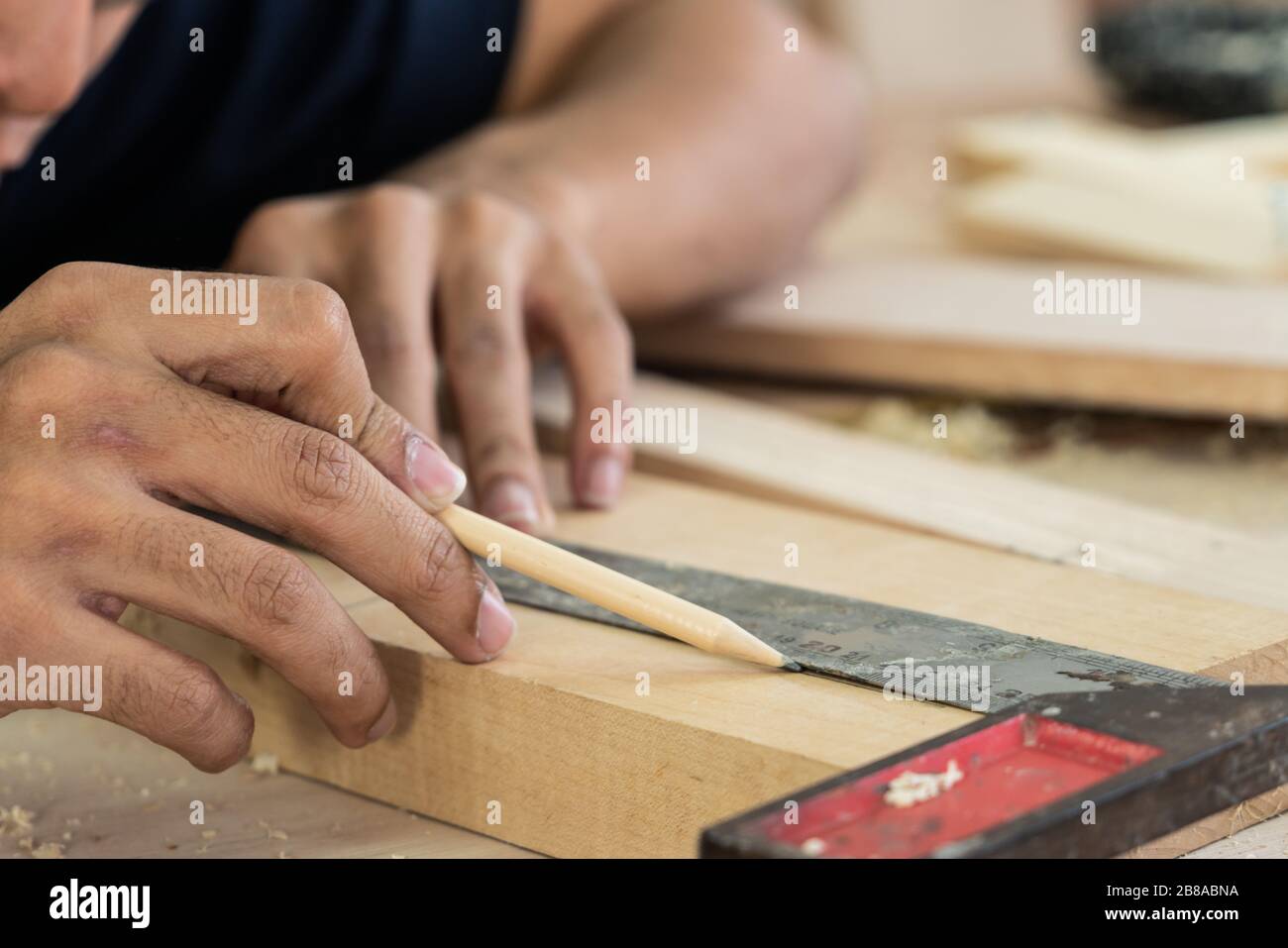 Carpenter working on wood craft at workshop to produce construction ...