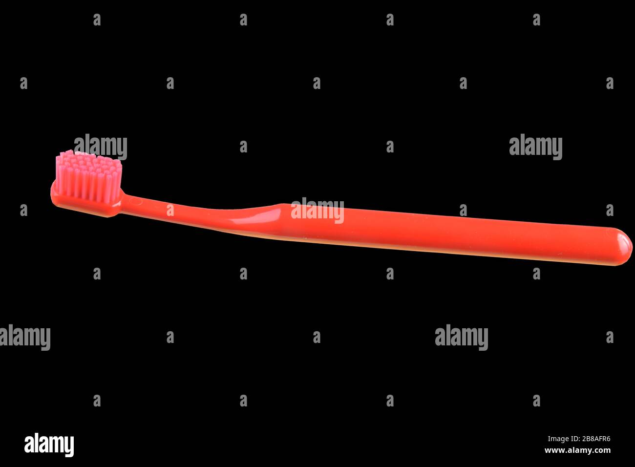 Red toothbrush isolated on the black background Stock Photo - Alamy