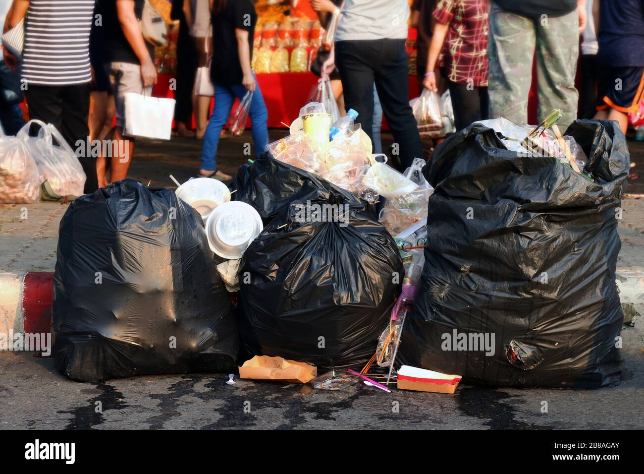 Pile of Garbage plastic black and trash bag waste many on the footpath ...