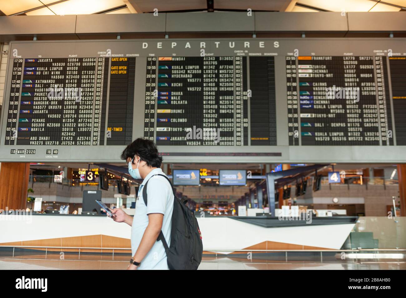 18.03.2020, Singapore, Republic of Singapore, Asia - A man walks past a ...