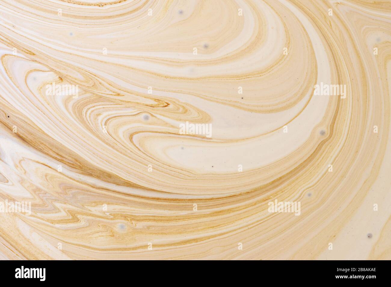 Close-up abstract caramel shapes latte art in coffee. Liquid texture ...