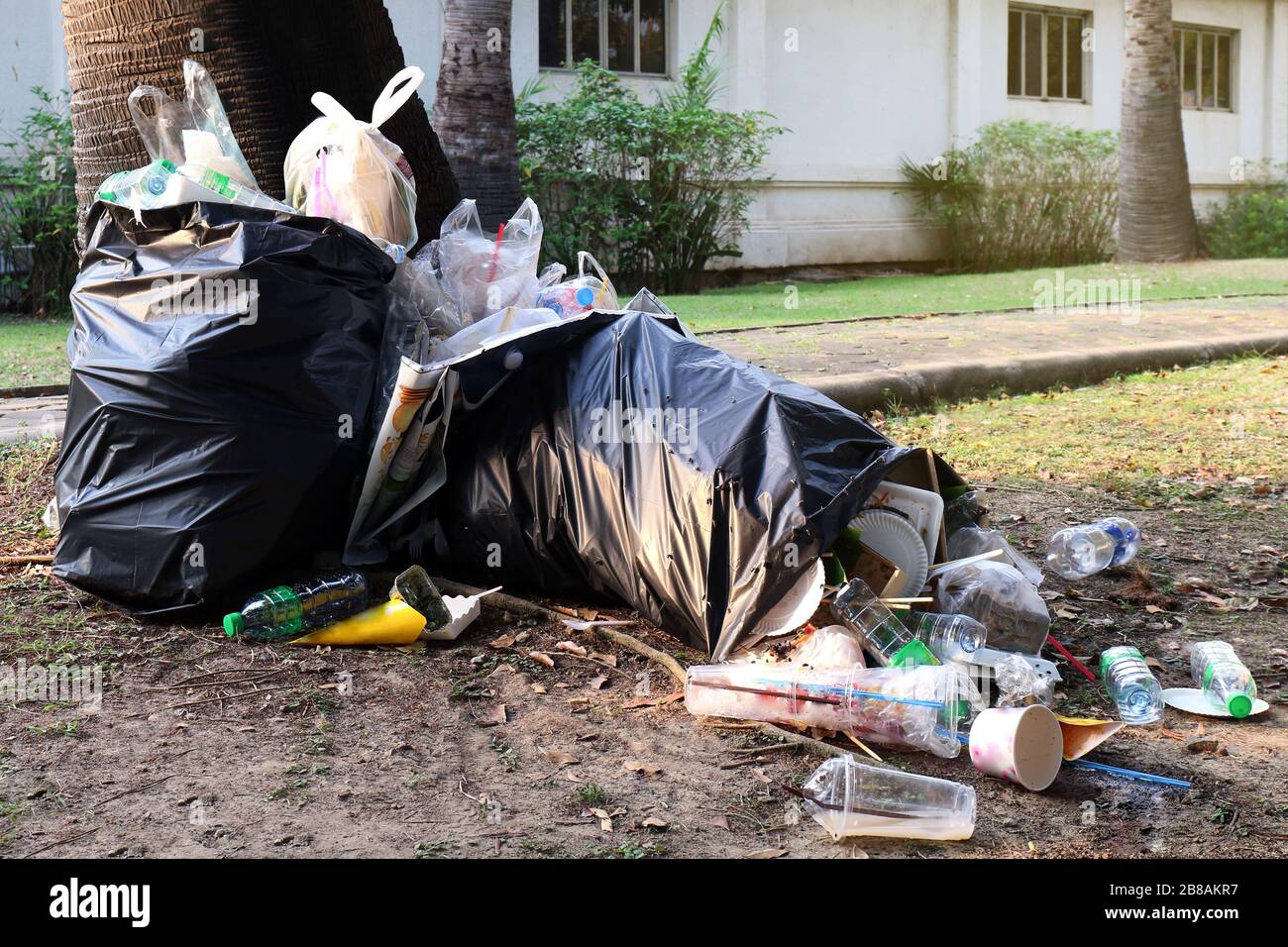 Pile of Garbage plastic black and trash bag waste many on the footpath ...