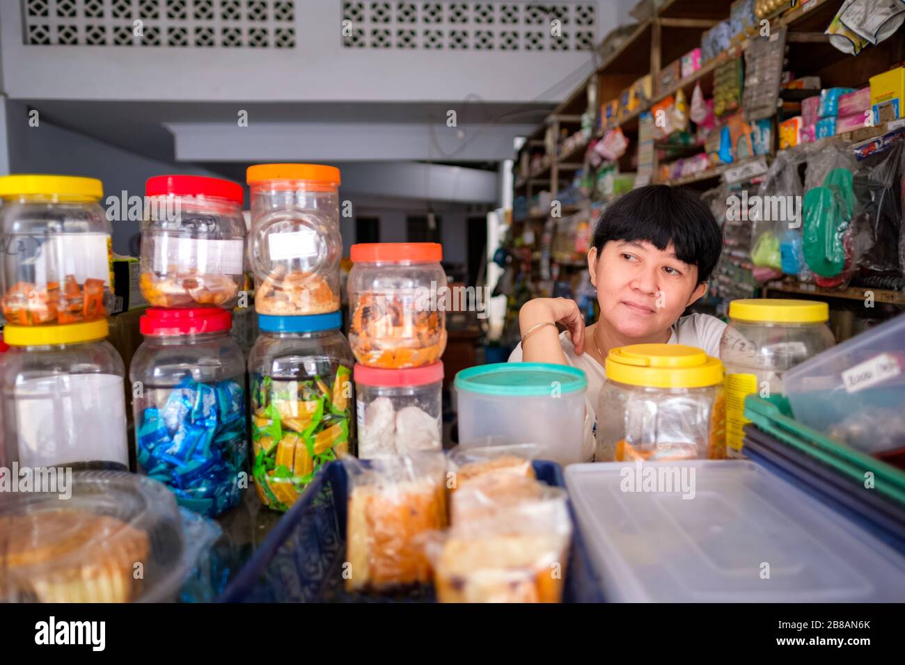 Asian Indonesian women in front of small local family-owned business ...