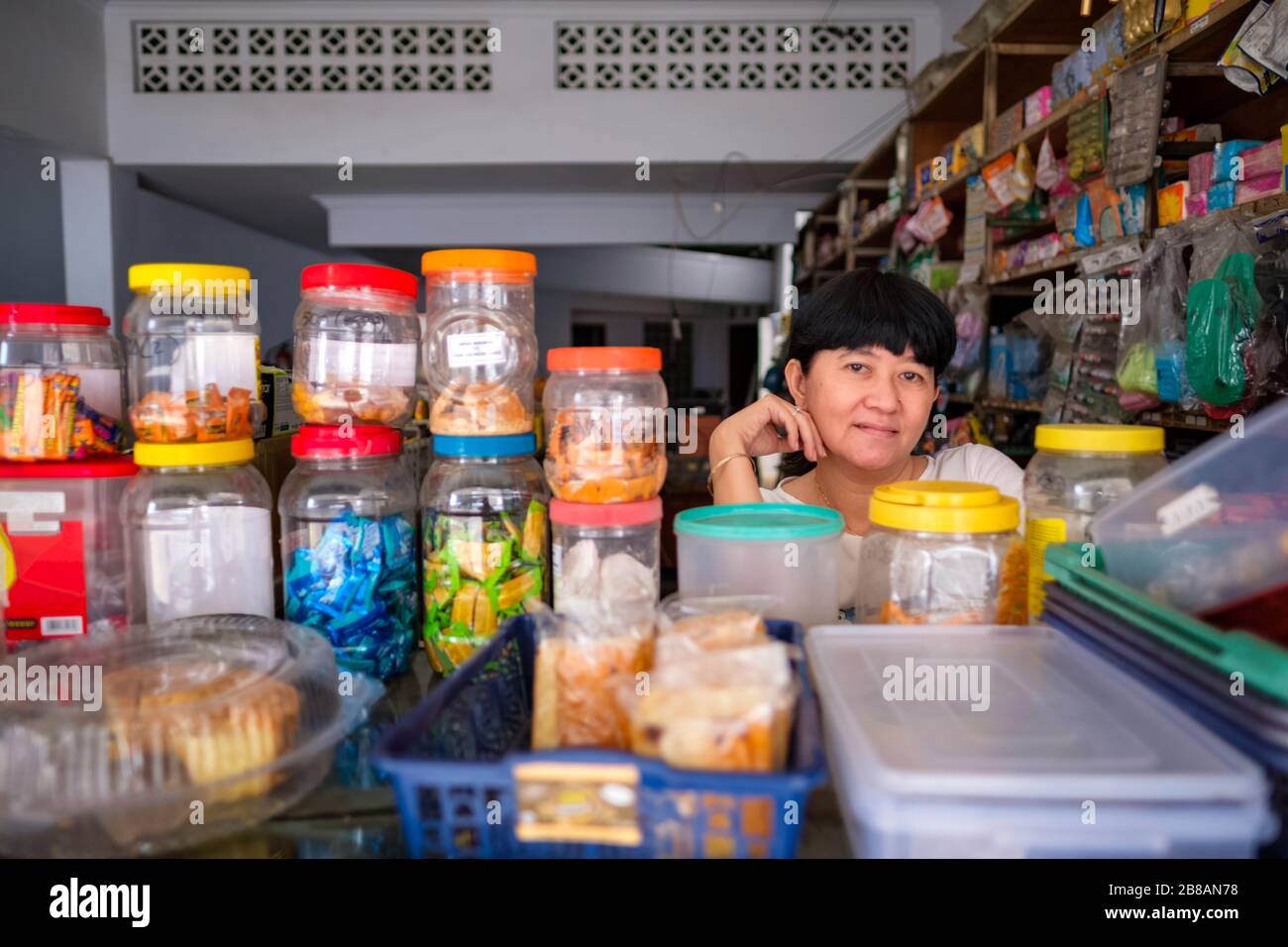 Asian Indonesian women in front of small local family-owned business ...