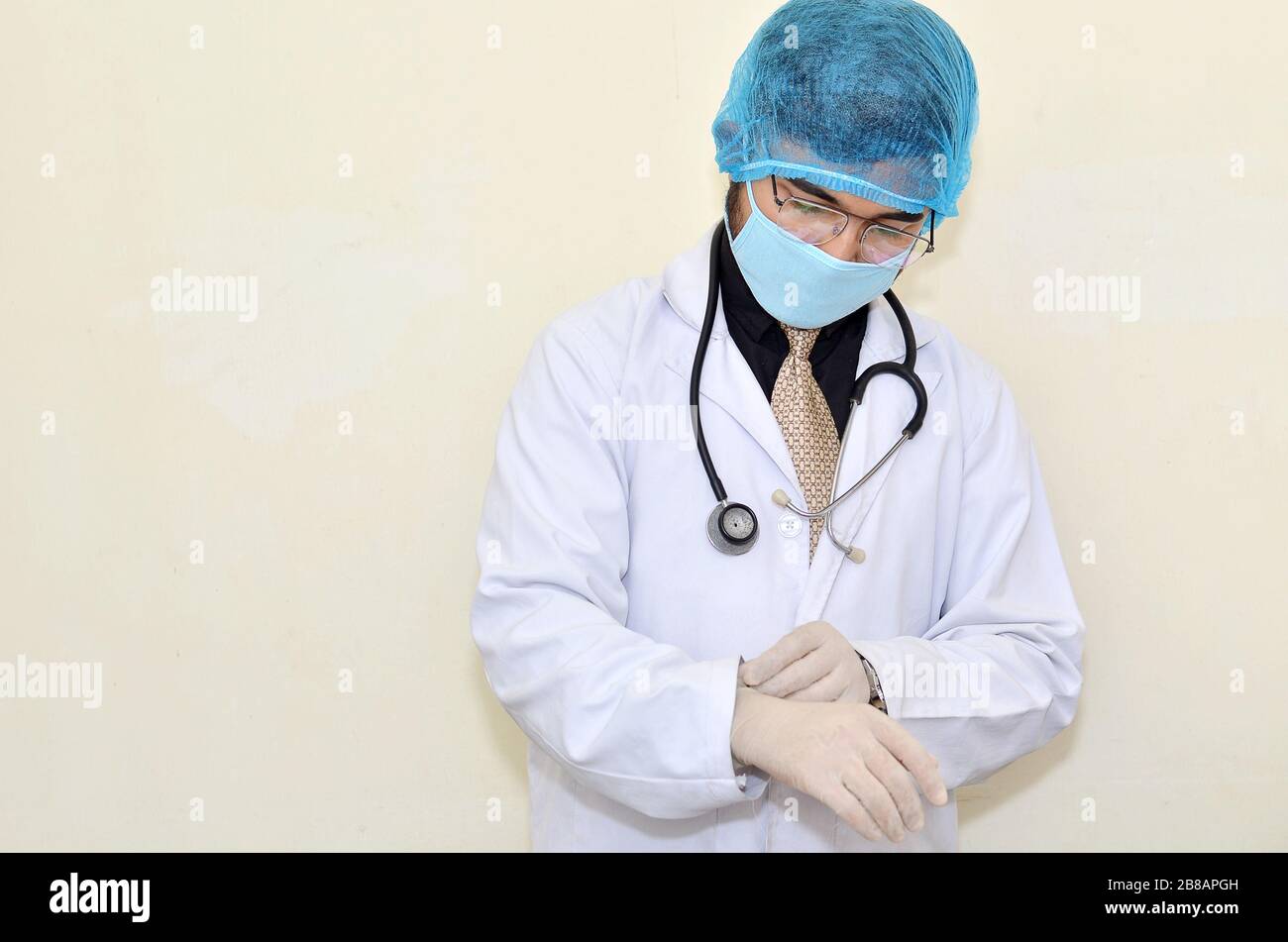 Doctor wearing medical protective gloves hi-res stock photography and ...