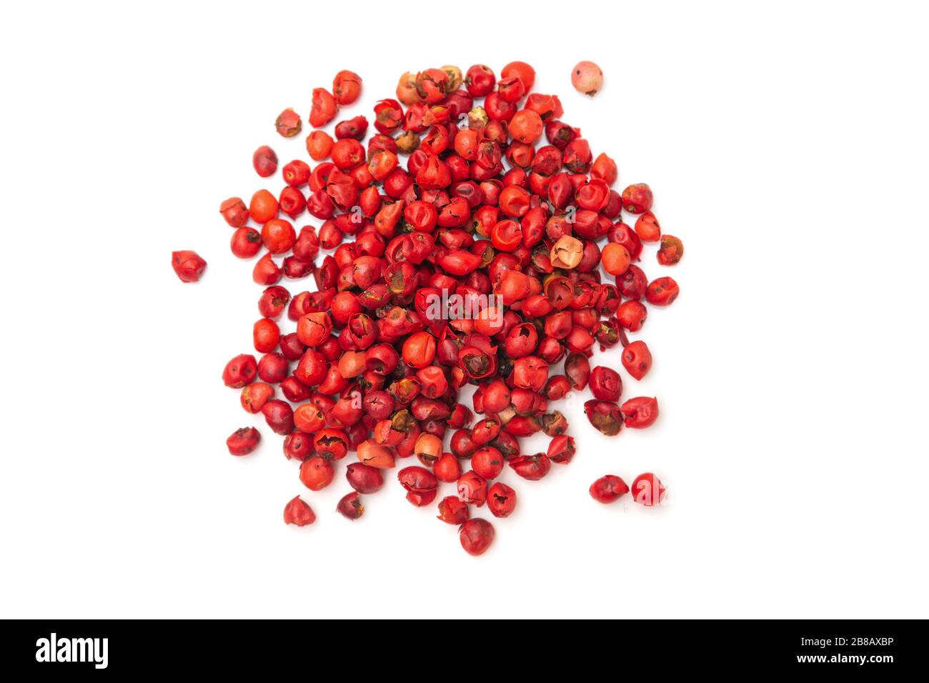 Pile of pink pepper corns on white background Stock Photo - Alamy