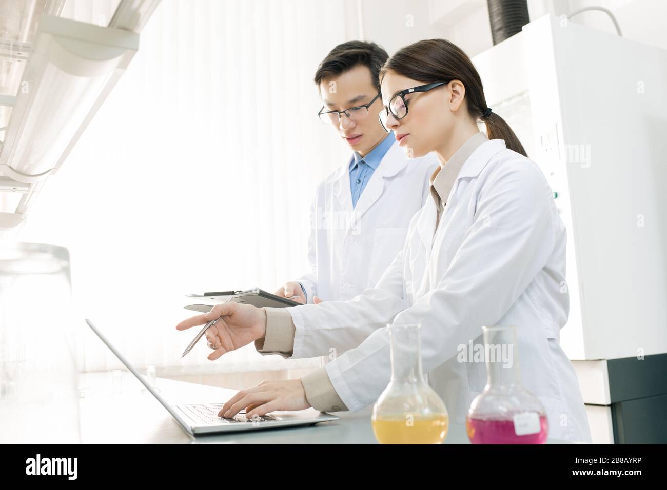Young female scientific researcher making presentation of new virus to ...
