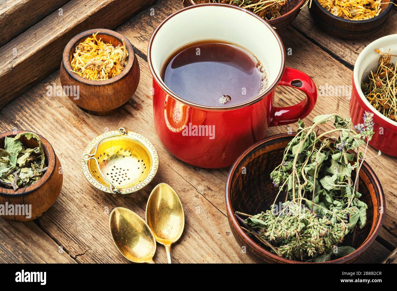 Cup with useful tea from medicinal herbs.Herbal tea ingredients Stock ...