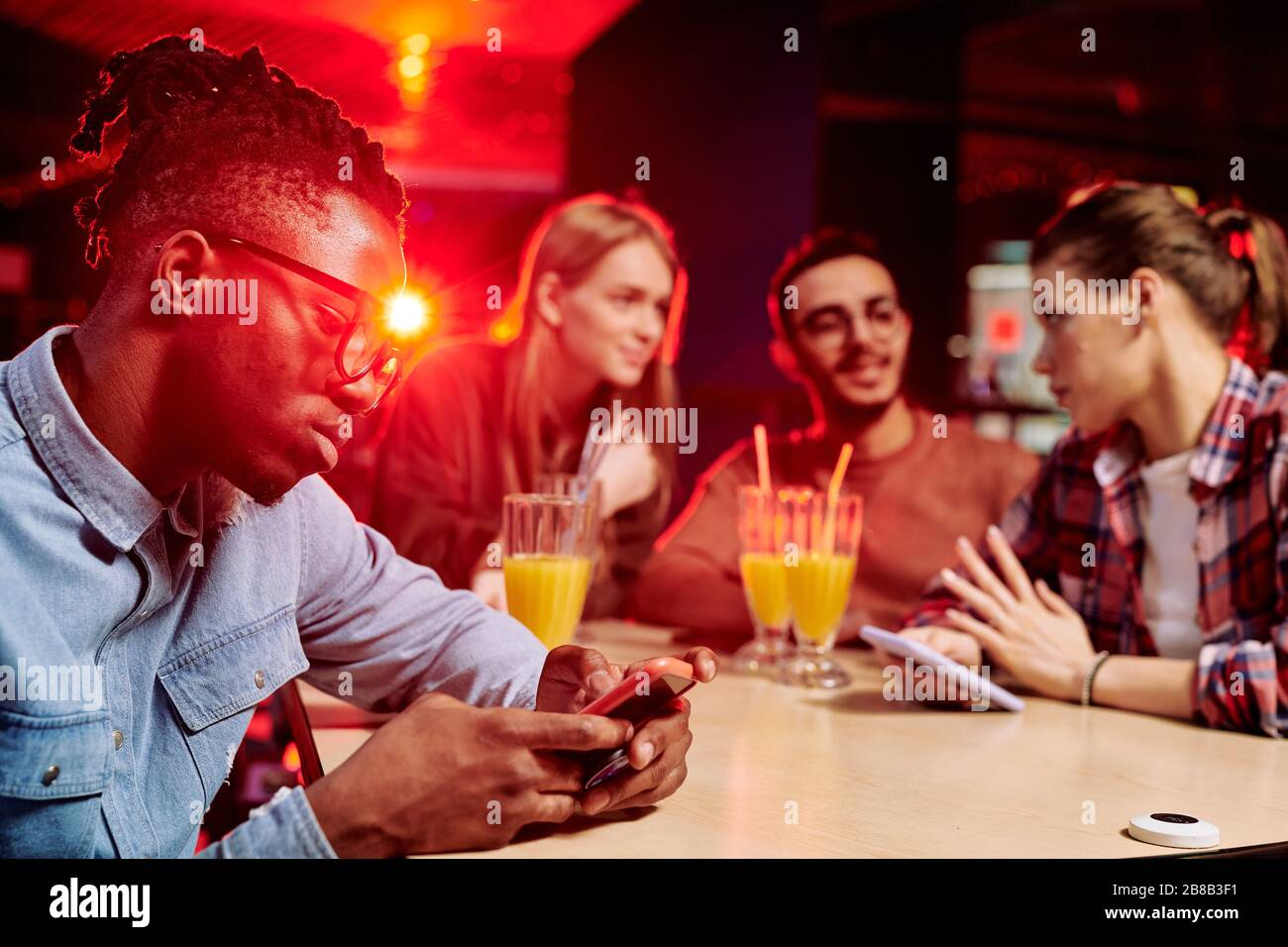 Multi ethnic friends scrolling social hi-res stock photography and ...