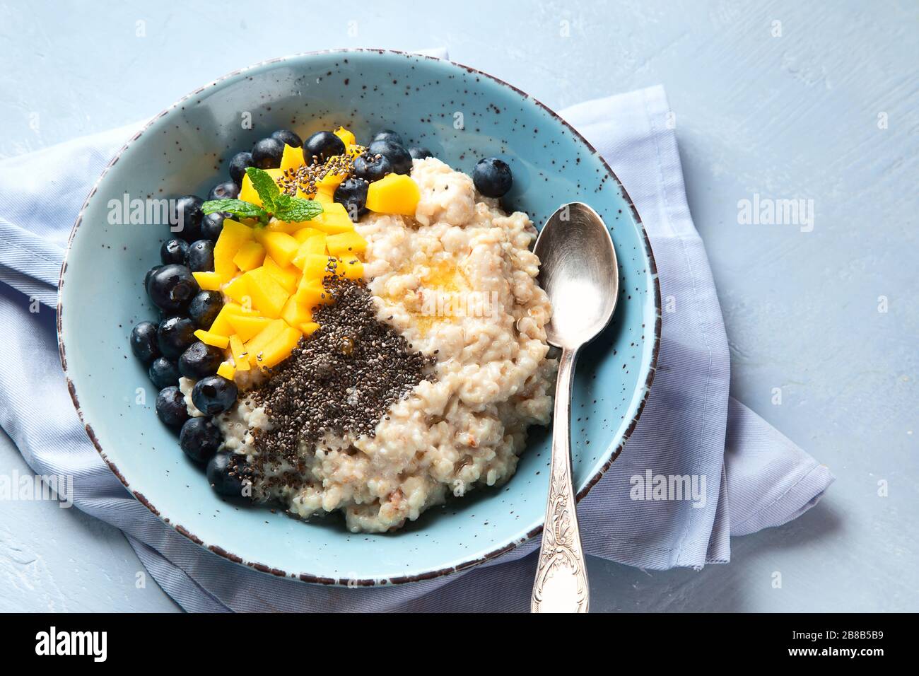 Oatmeal porridge with berries and fruit on grey background for Healhy ...