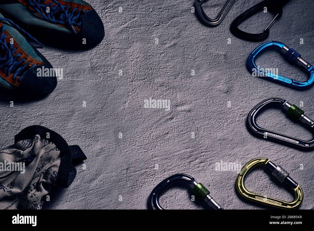 Overhead closeup shot of different colored carabiners and shoes on a ...