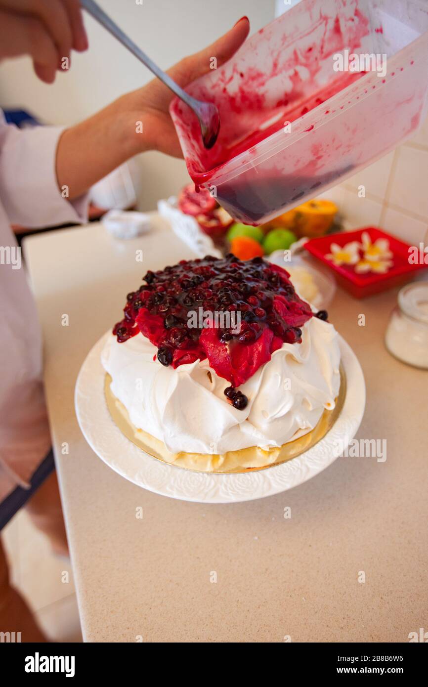 Making Pavlova cake with fruit cream Stock Photo - Alamy