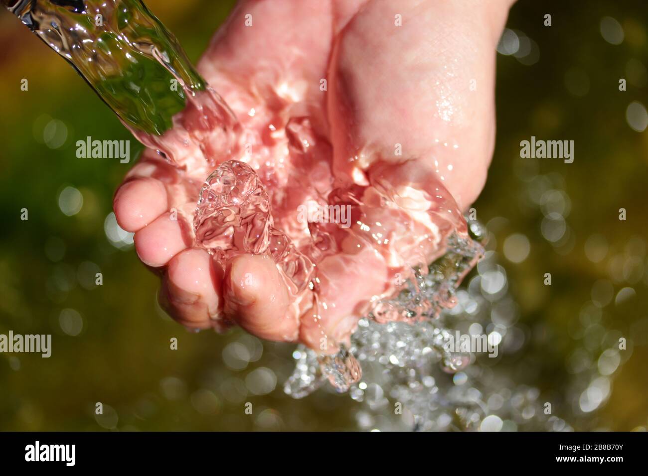 natural spring water in the hands Stock Photo - Alamy