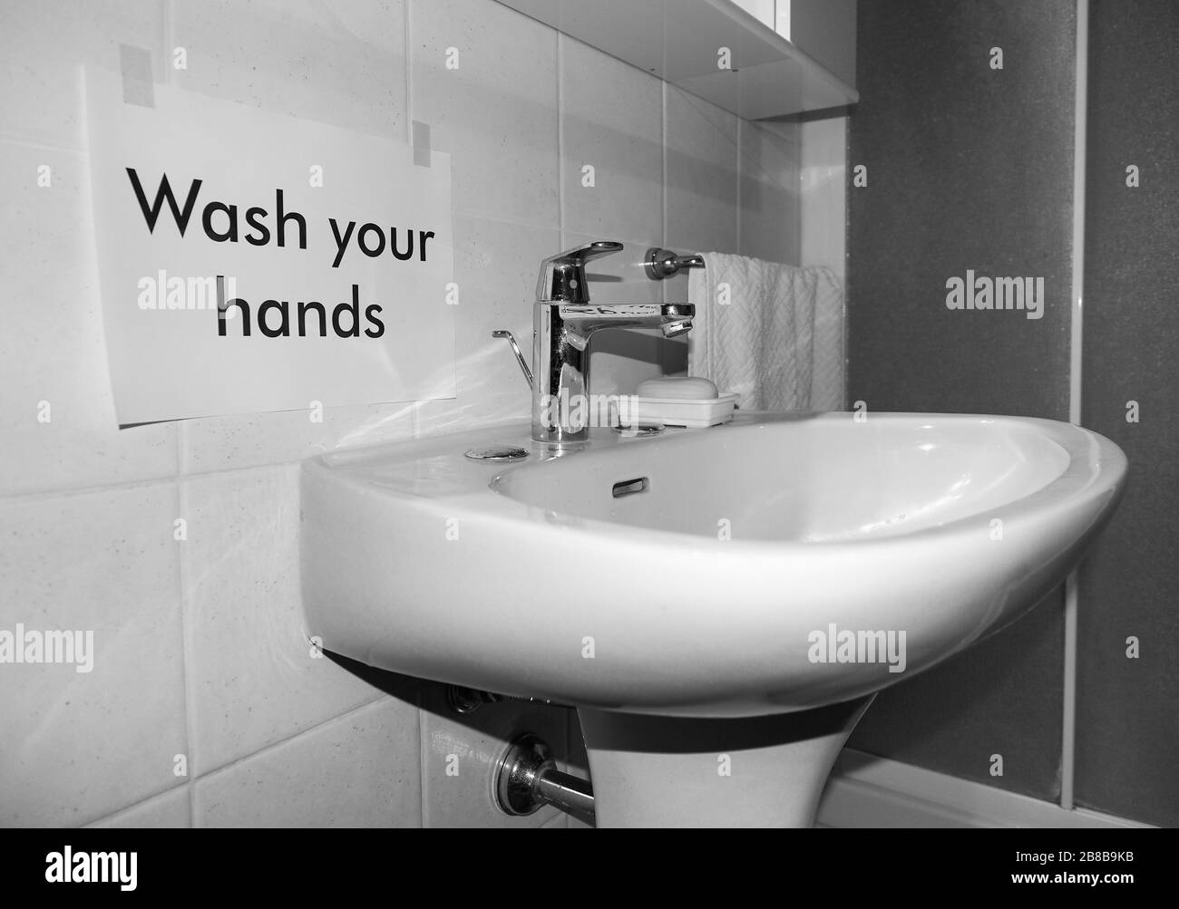 Wash your hands sign near bathroom basin Stock Photo - Alamy