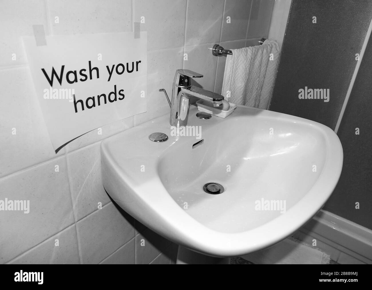 Wash your hands sign near bathroom basin Stock Photo - Alamy