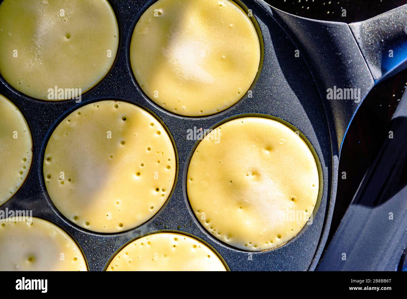 pancake frying pan with smile face pancake cooking on cooker in kitchen ...