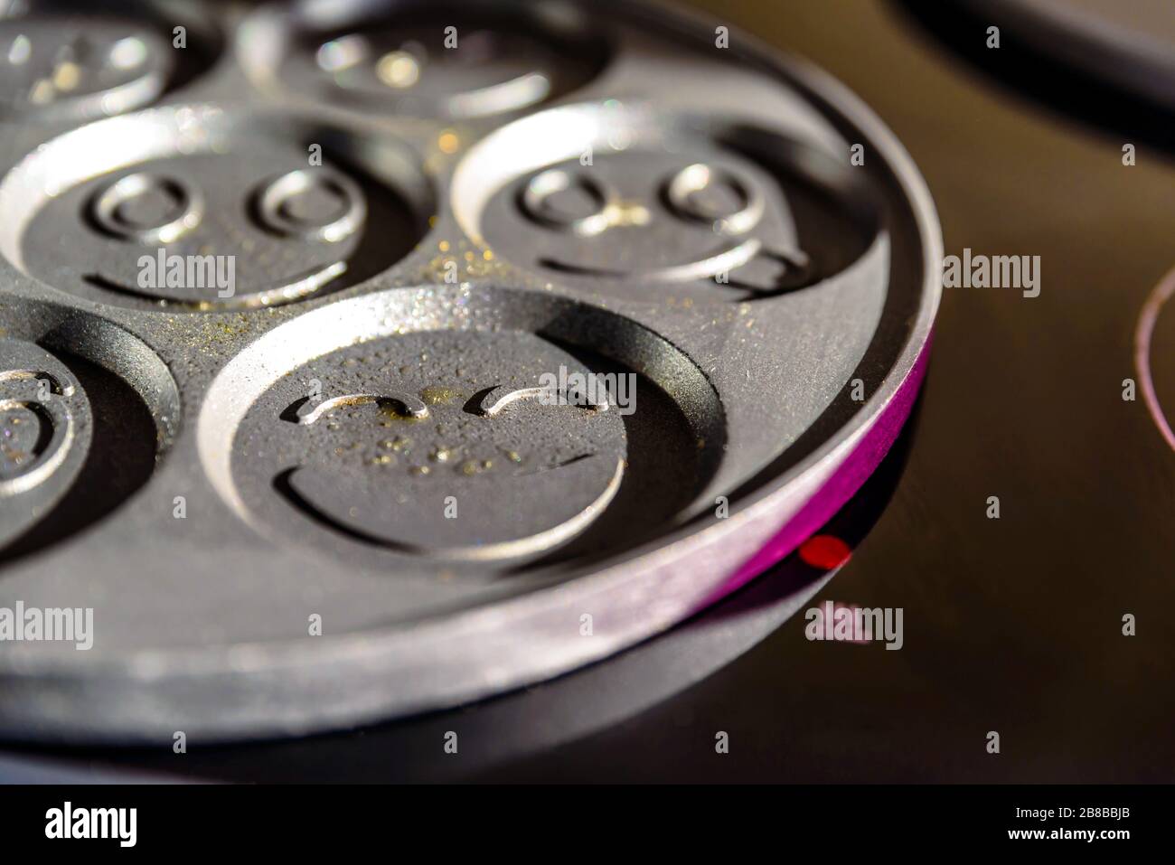 pancake frying pan with smile face pancake cooking on cooker in kitchen ...