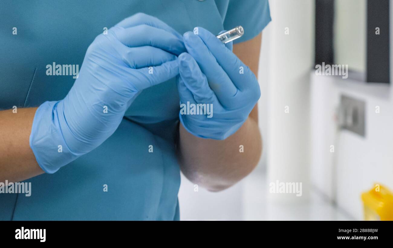 female hands in medical gloves prepare injection for skincare ...