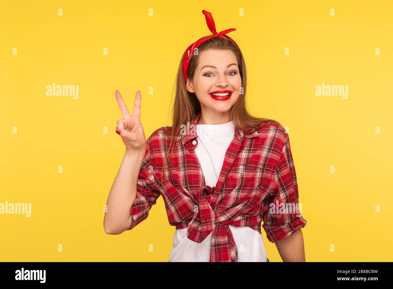 Optimism and success. Portrait of happy winner, pinup girl in checkered ...