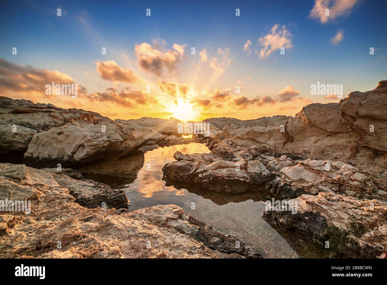 Beautiful colorful sunset near the sea at Cyprus with dramatic clouds ...