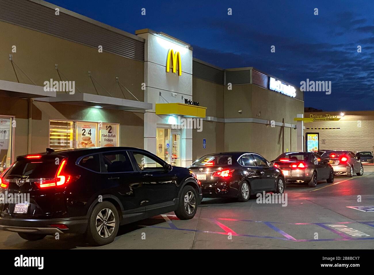 Cars wait in drive through line at McDonald's restaurant in the wake of ...