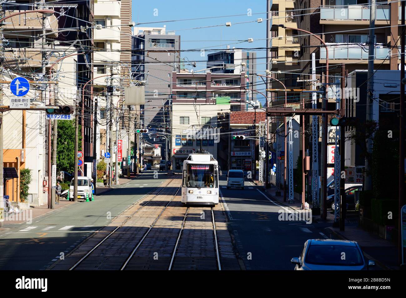 Tram on the street alongside other vehicles in the city Stock Photo - Alamy