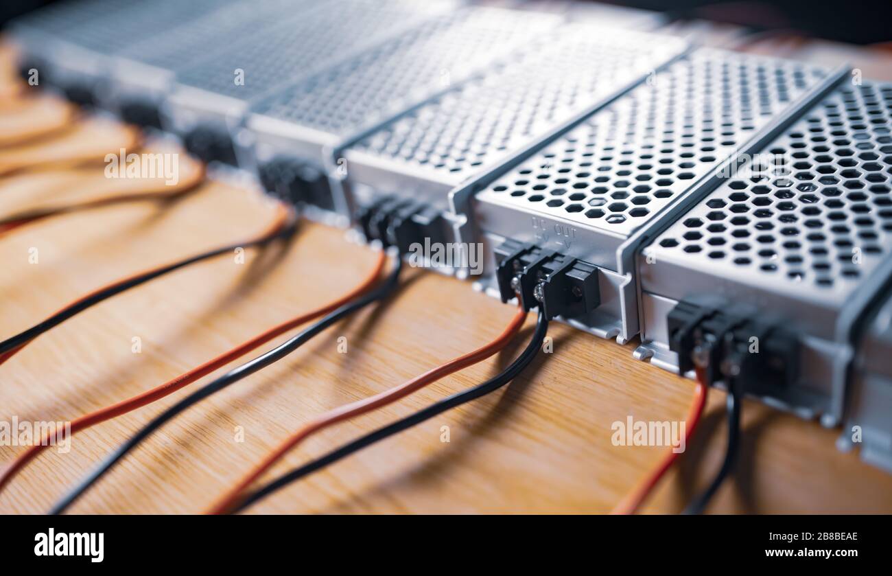 Close up of the metal mesh cases of power supply and wires are on a ...
