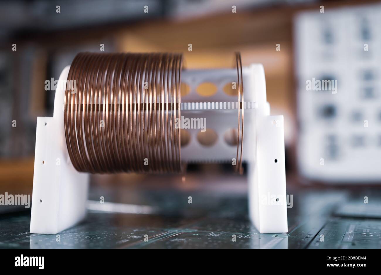 Close-up large and small coils with copper wire stand on a green ...