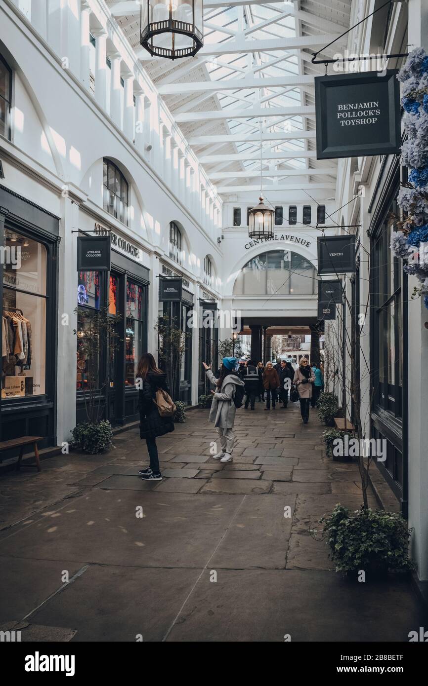 London, UK - March 06, 2020: People walking past the shops inside ...