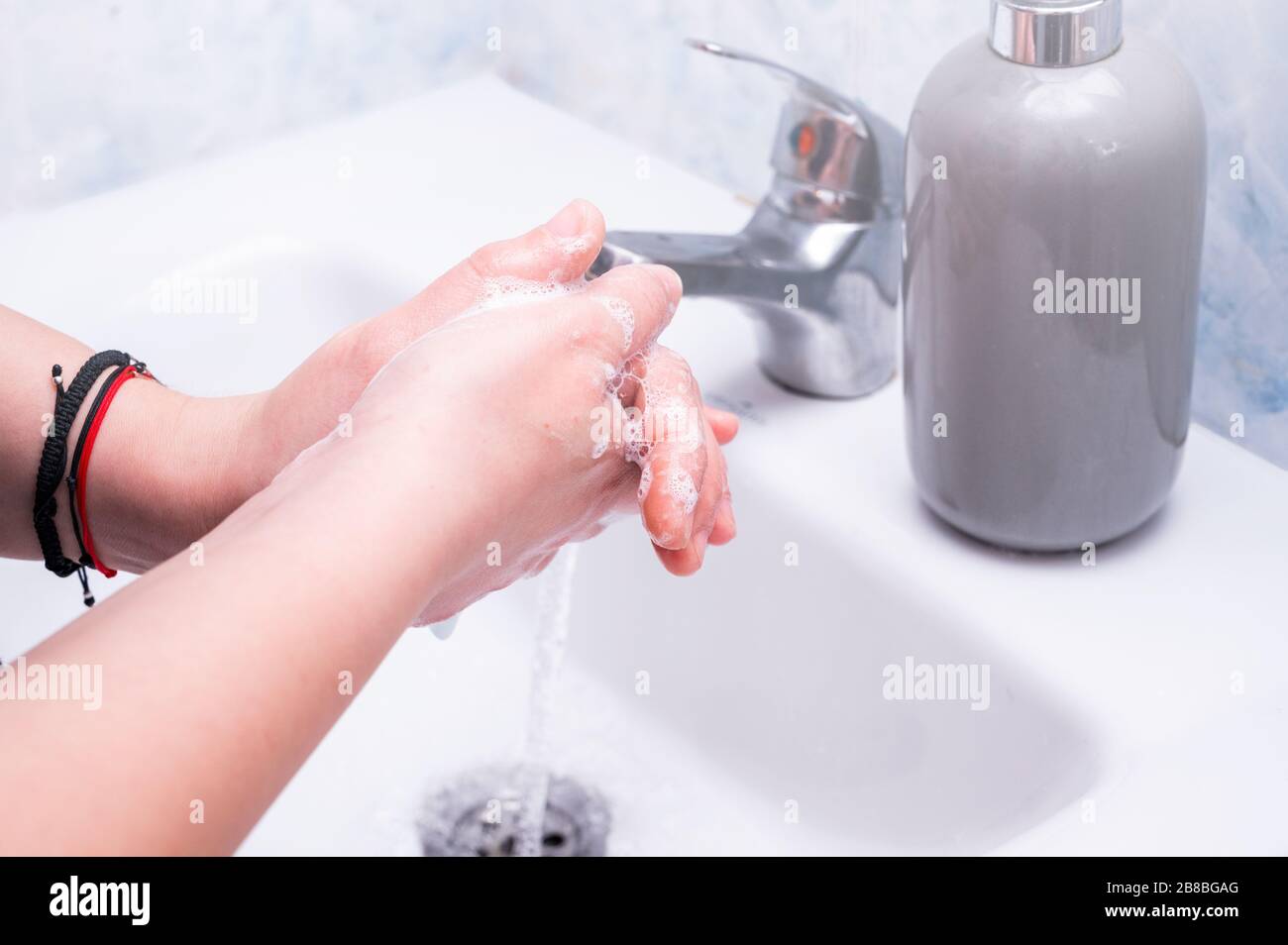 Woman use soap and washing hands under the water tap. Hygiene concept ...