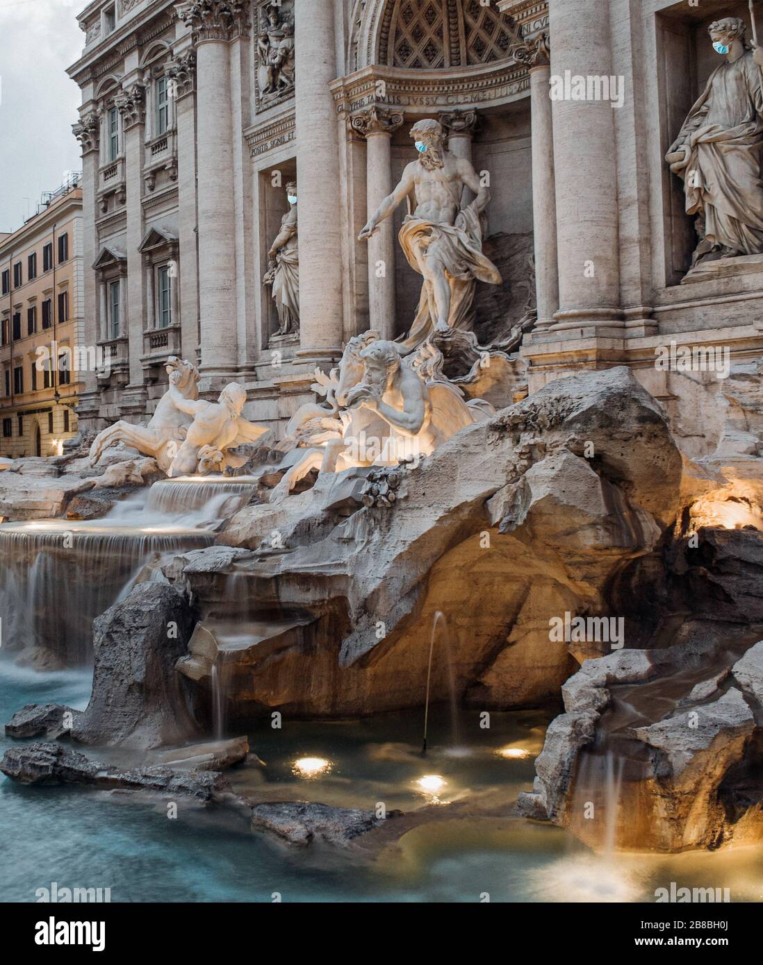 Statues at the trevi fountain with a surgical masks Stock Photo - Alamy