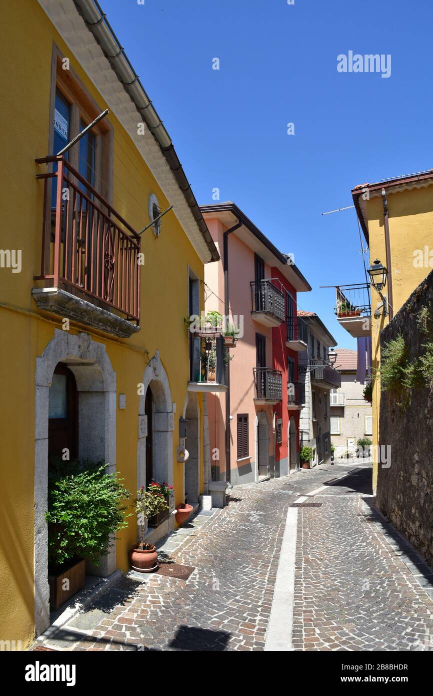 A narrow street between the houses of the medieval village of Nusco, in ...