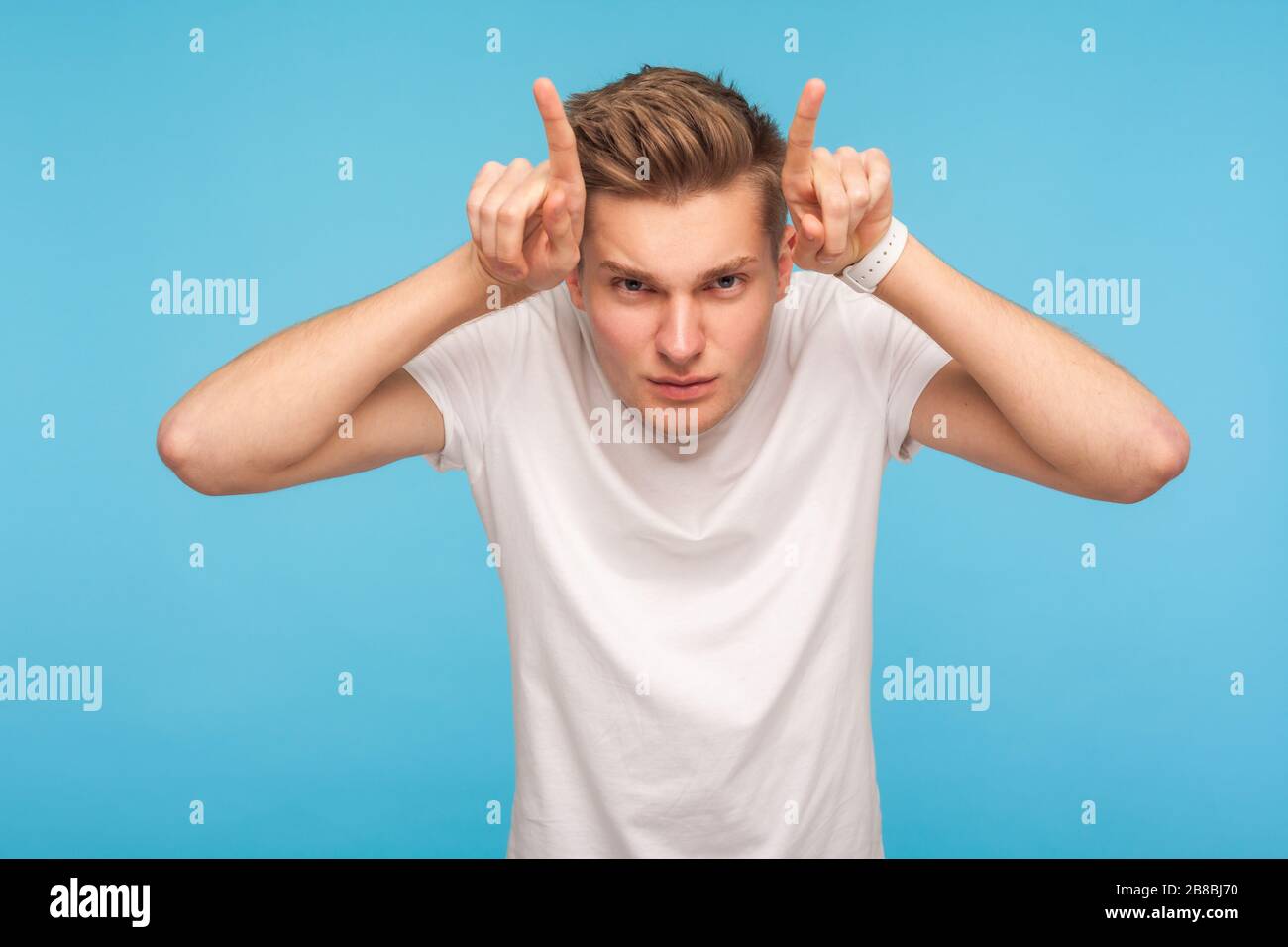 I'm dangerous! Portrait of angry man in white t-shirt threatening to ...