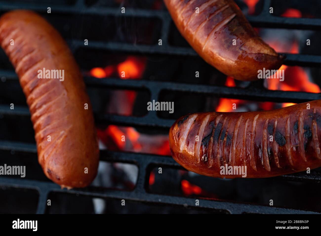 Roasted sausages on the grill. The barbecue season has begun, hot coal ...